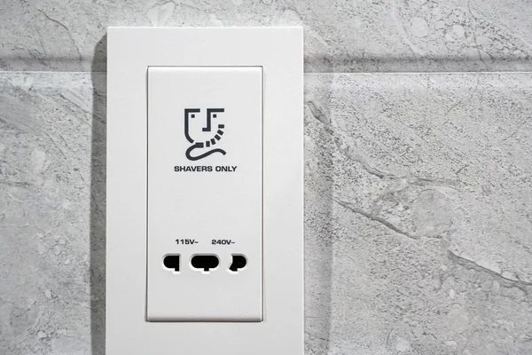white shavers only sign electrical outlet in restroom - Stock Image ...
