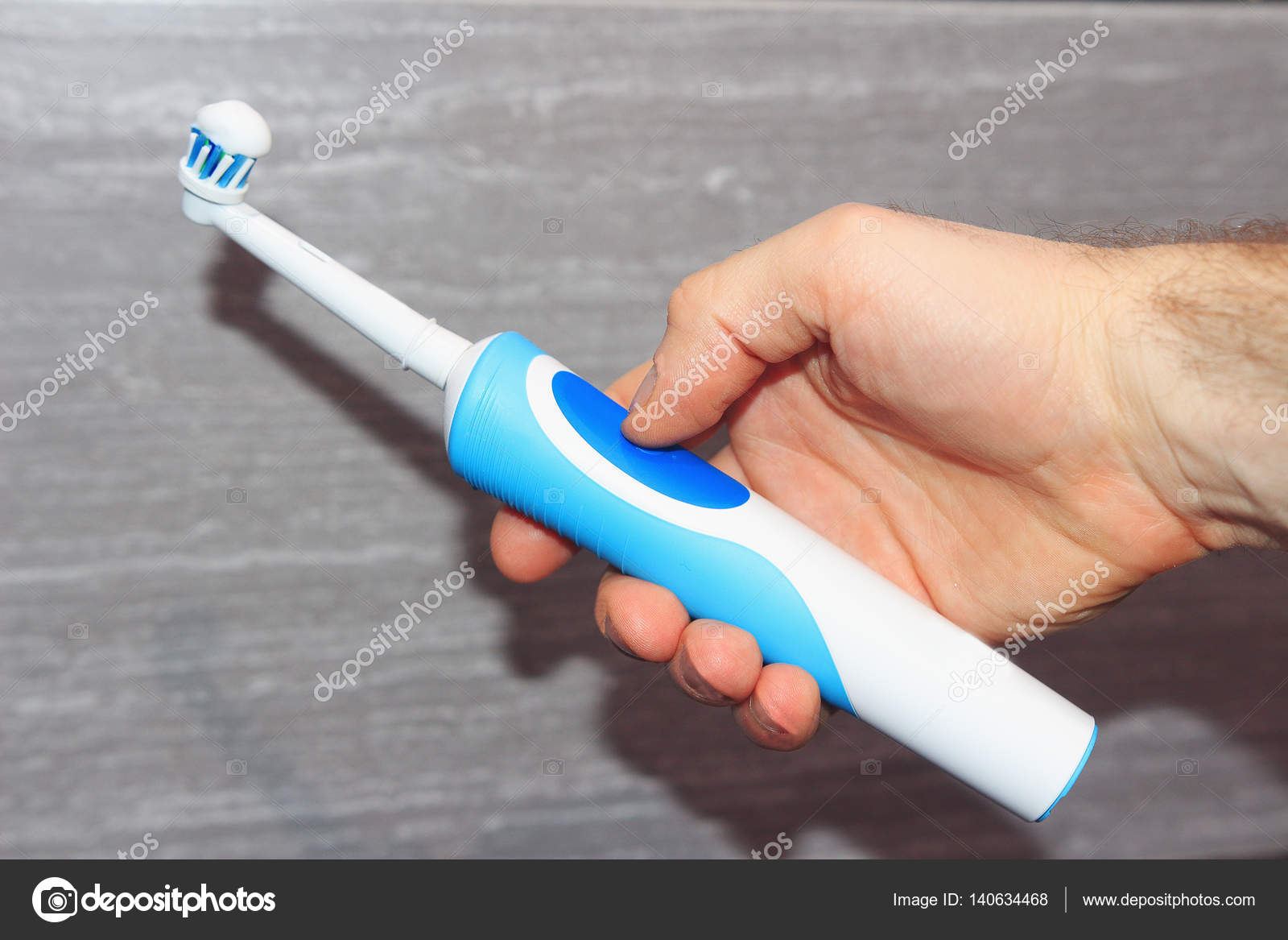 Human hand holding an electric toothbrush. Stock Photo by ©DzmitRock87 ...