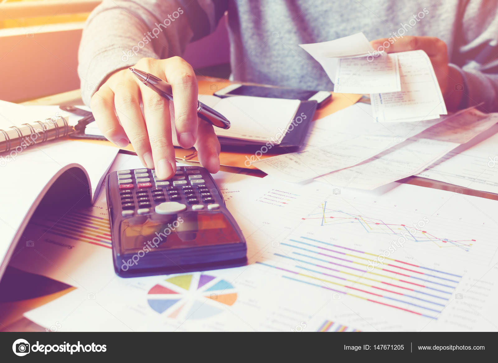 Man using calculator and calculate cost with holding bill in hom ...