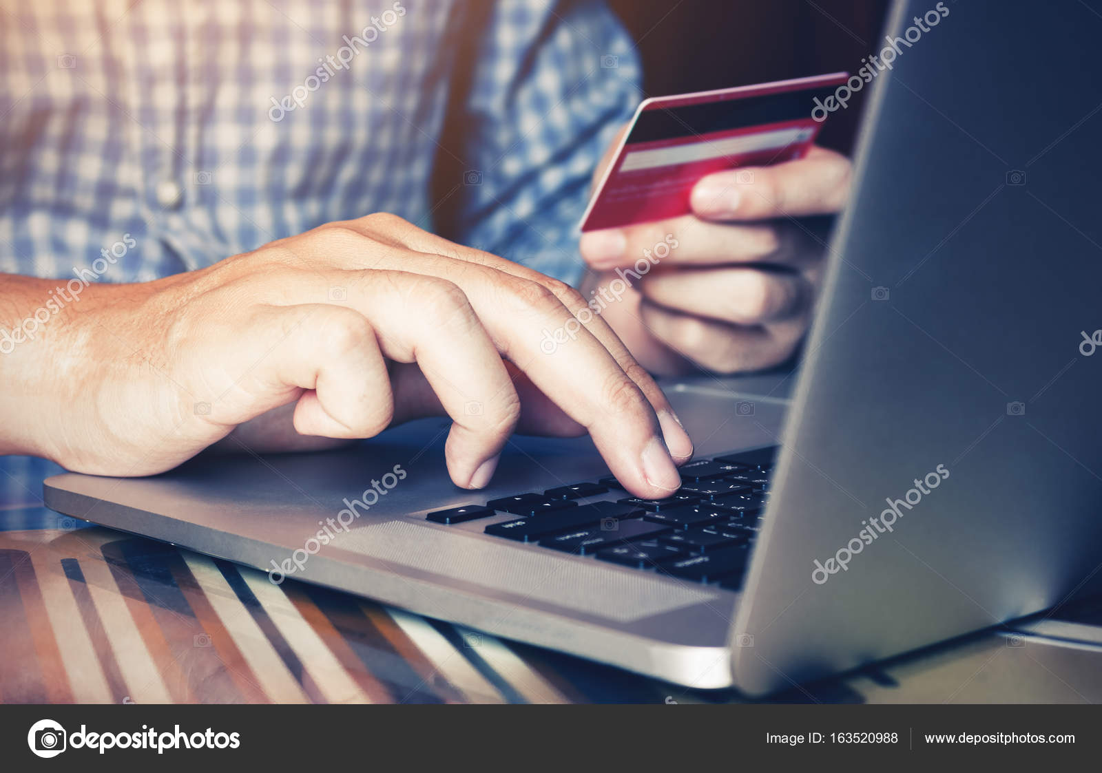 Man's hand typing on keyboard laptop and holding debit card for — Stock ...