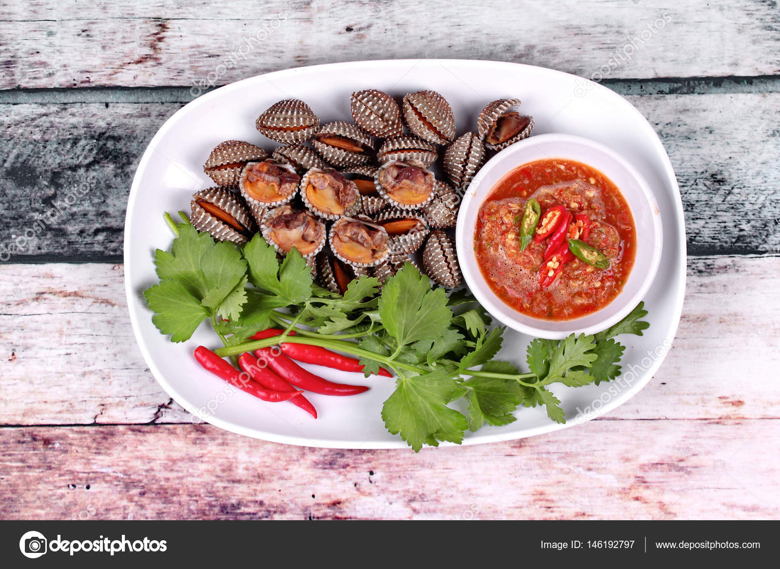 Soft-boiled blood cockles shell served with spicy sauce. Stock Photo by ...