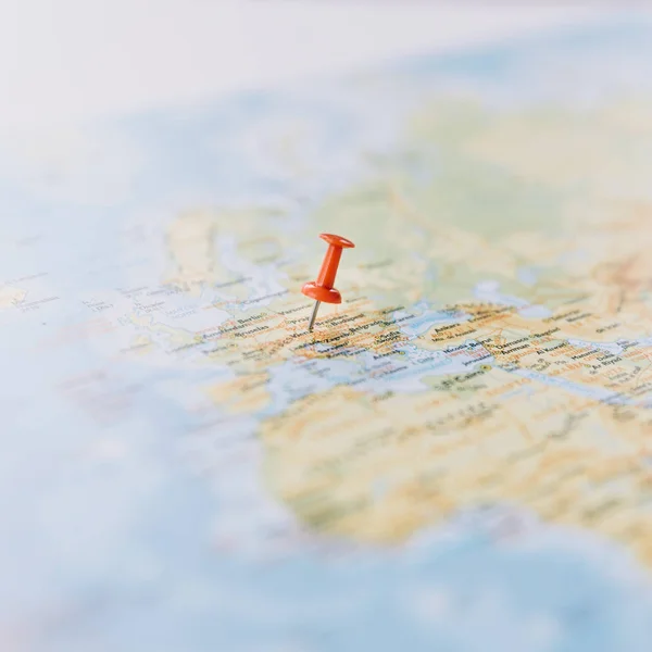 Close-up of a red thumb tack on defocused world map - Stock Image ...