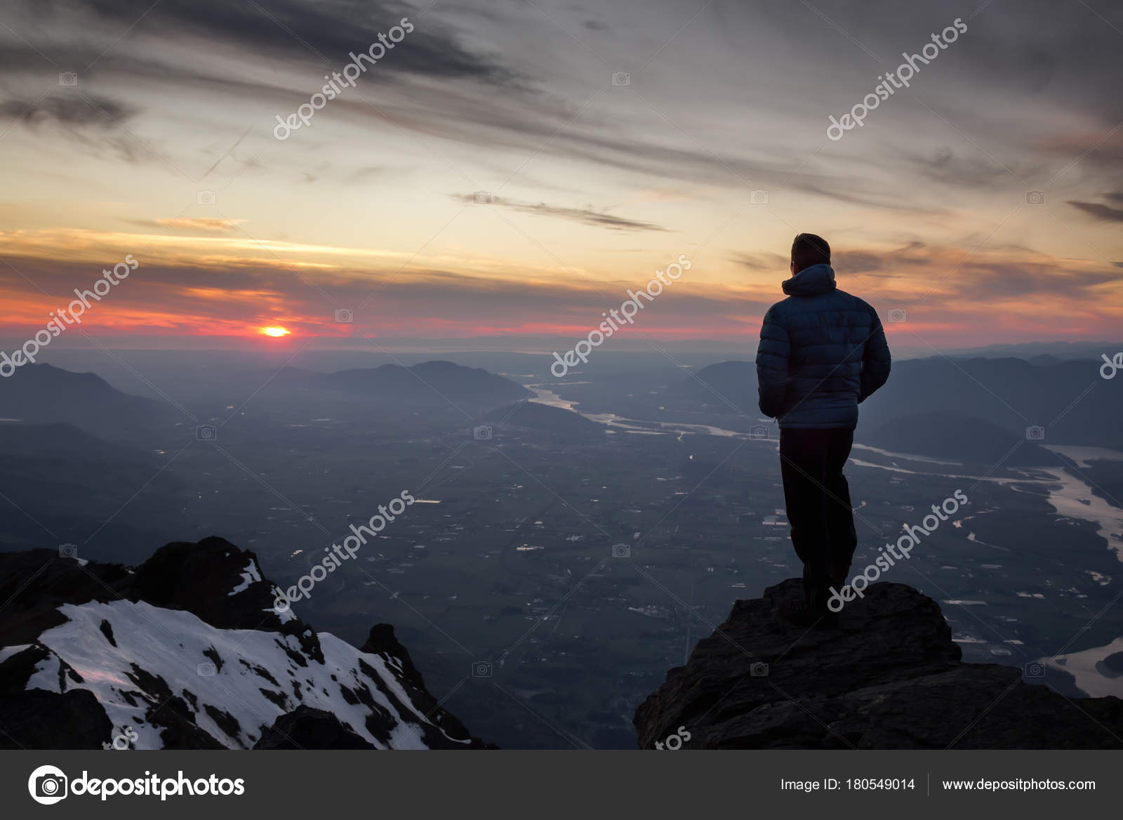 Adventurous man on top of the mountain — Stock Photo © edb3_16 #180549014