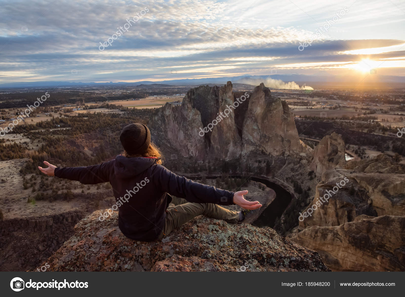 Adventurous Man Sitting Open Arms Top Cliff Vibrant Sunset Taken ...