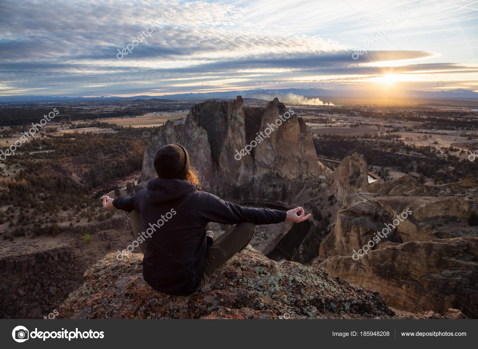 Adventurous Man Sitting Meditation Pose Top Cliff Vibrant Sunset Taken ...