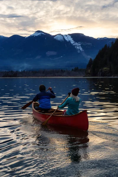 Adventurous people on a wooden canoe are enjoying the beautiful ...