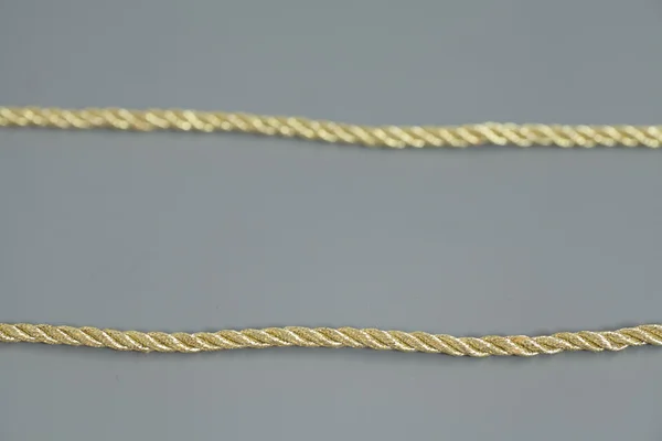 Golden rope isolated on gray background - Stock Image - Everypixel