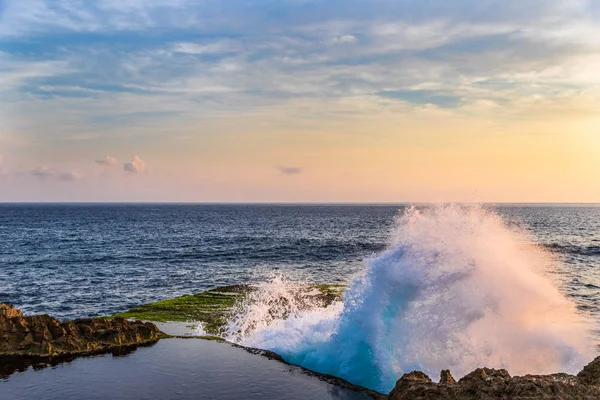 Arching wave breaking against cliff at Devil's Tear, on the coast of ...