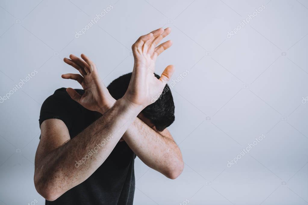 Man trying to protect himself with his arms — Stock Photo ...