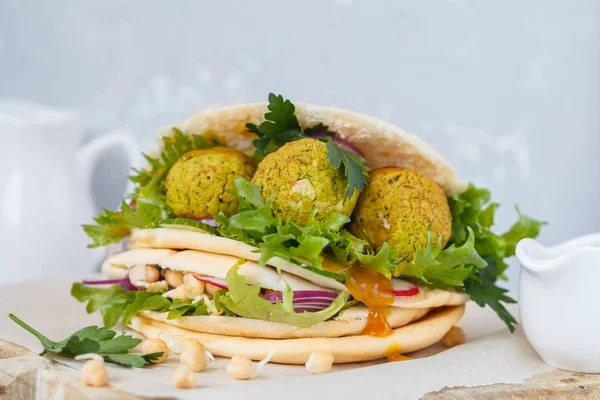 Fresh baked falafel in pita with vegetables, sprouts chickpeas a ...