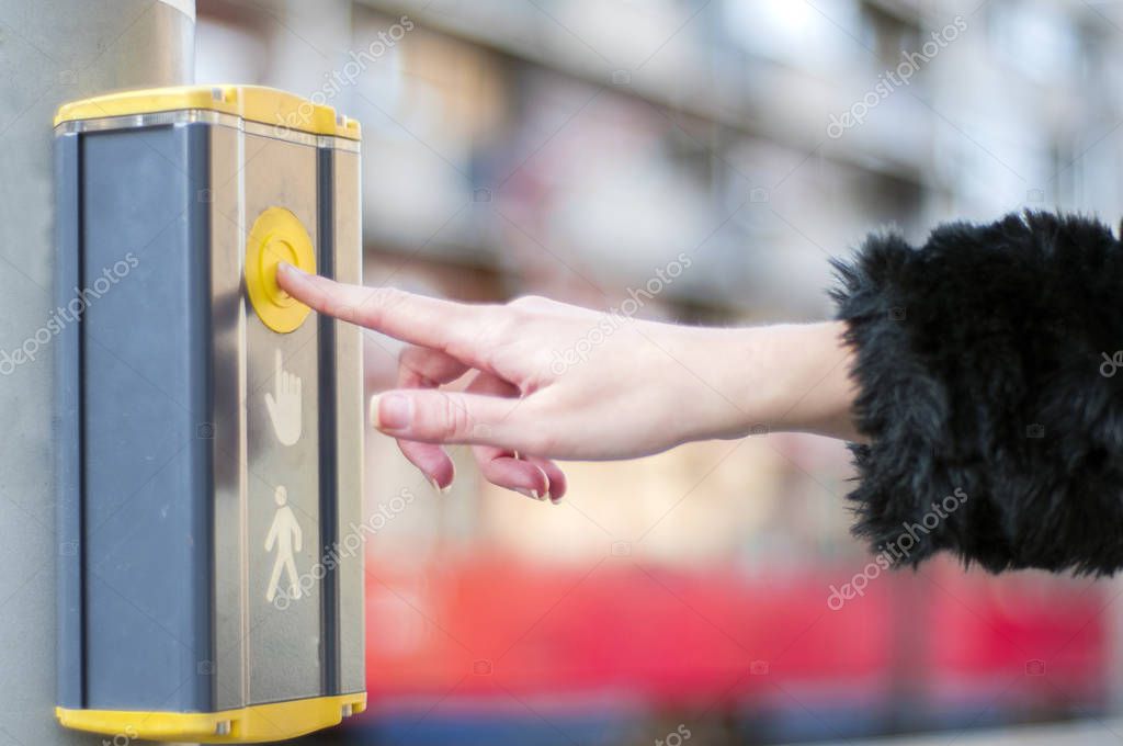 Female hand pushing button for traffic light. Use traffic lights at the ...