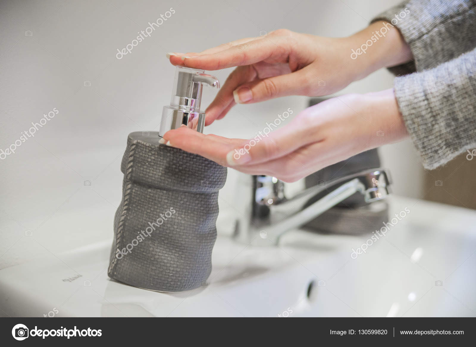 Female hands using wash hand sanitizer gel pump dispenser. A hand soap ...