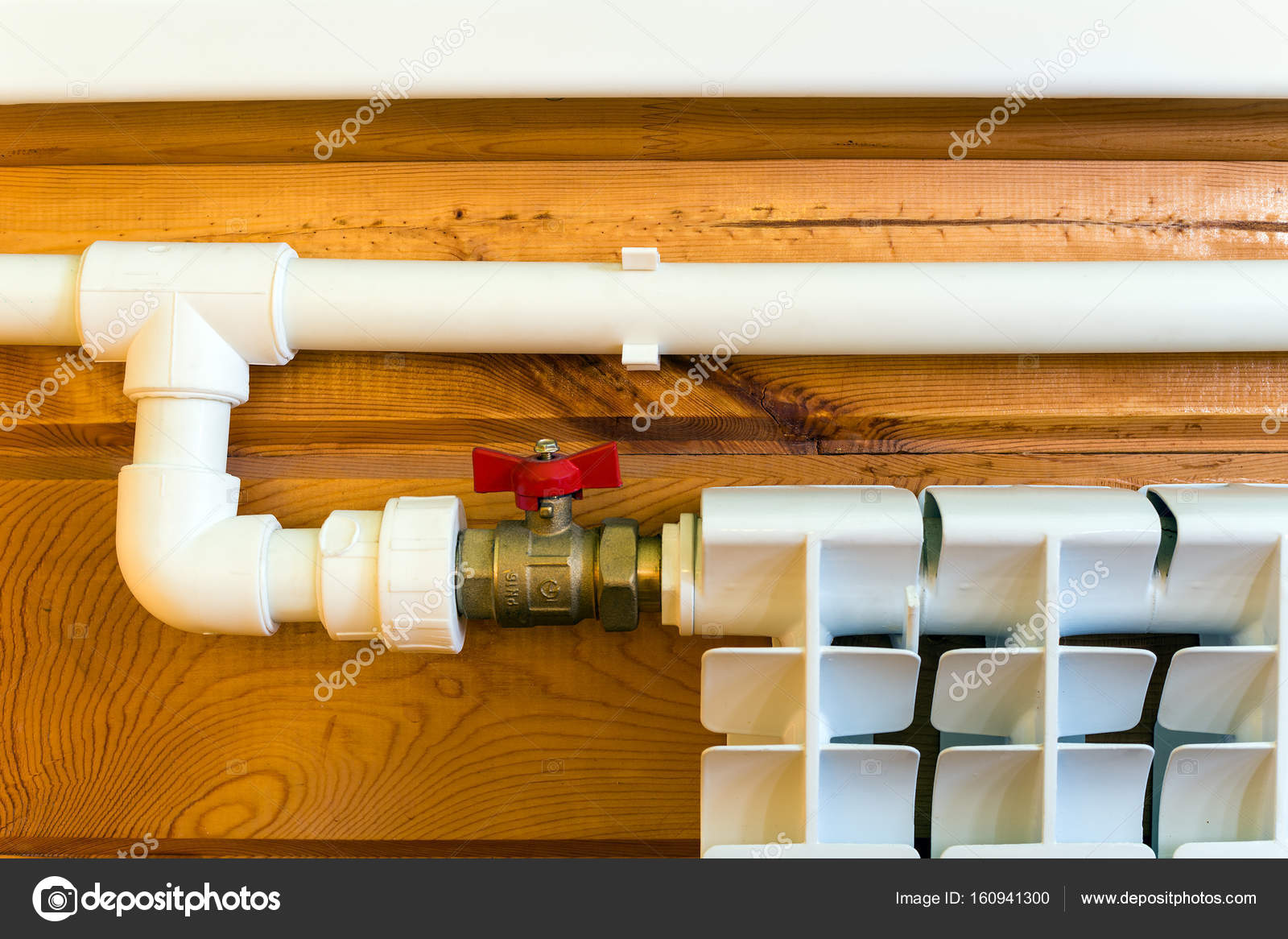 Heating radiator and polypropylene pipes in a wooden house Stock Photo ...