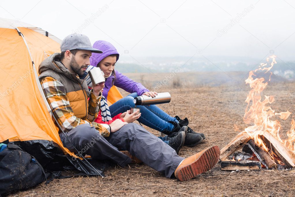 Family drinking tea near burning fire — Stock Photo © RomanPashkovsky ...