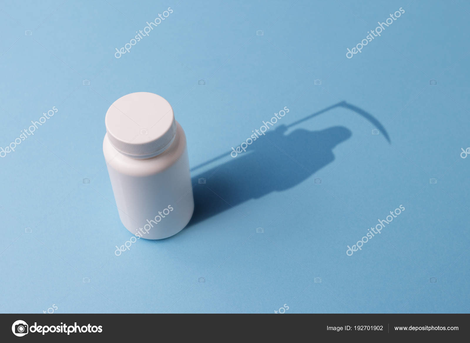 Plastic bottle with pills and a shadow in the shape of Death wit ...