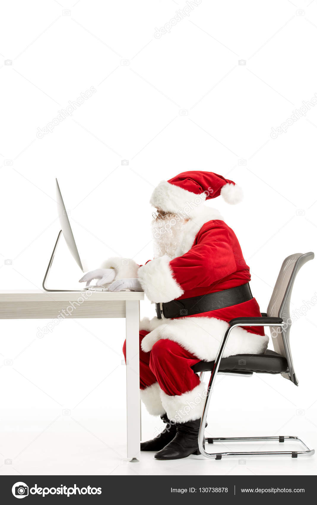 Santa Claus using computer — Stock Photo © ArturVerkhovetskiy #130738878