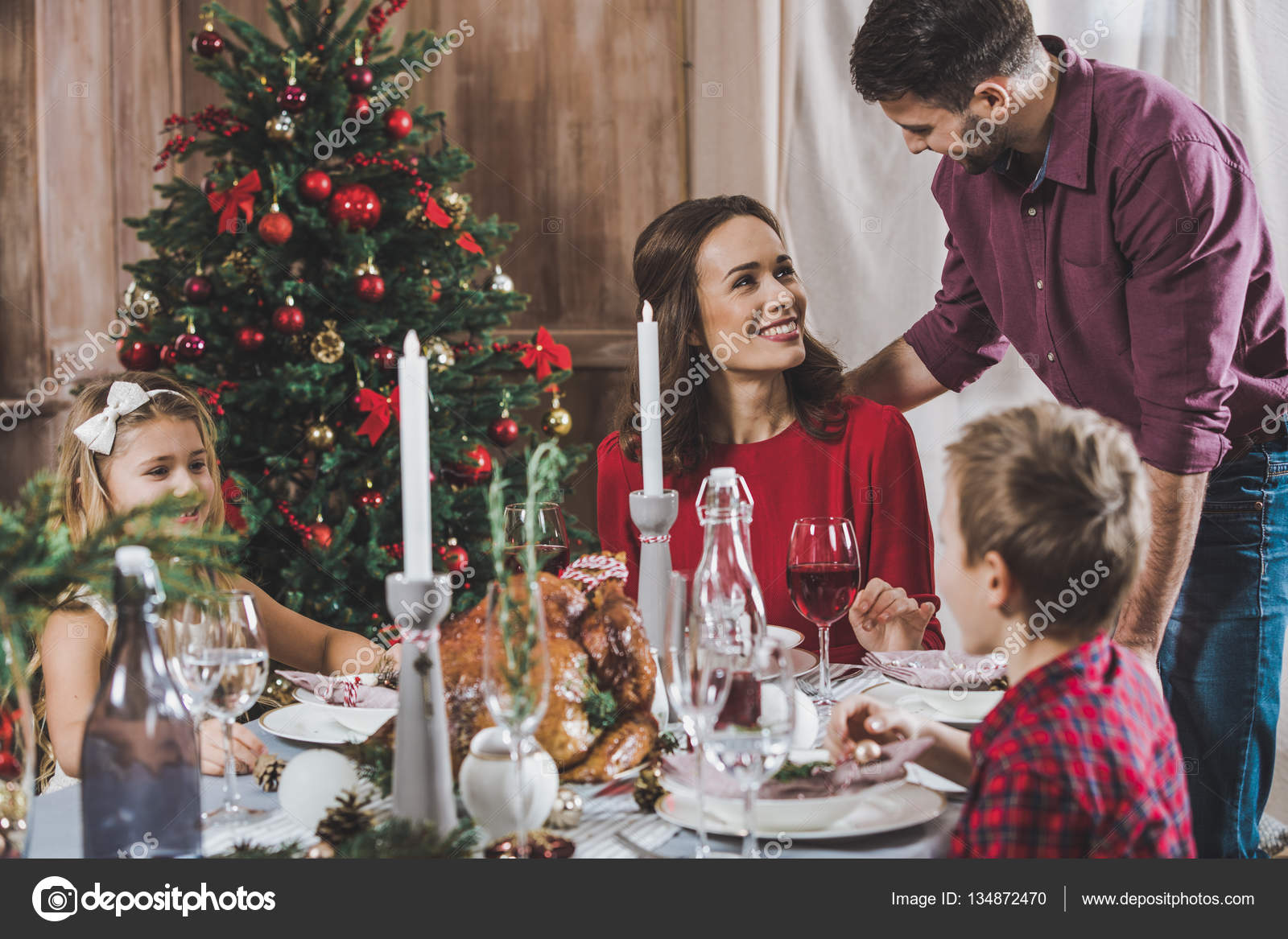 Happy family at holiday table — Stock Photo © ArturVerkhovetskiy #134872470