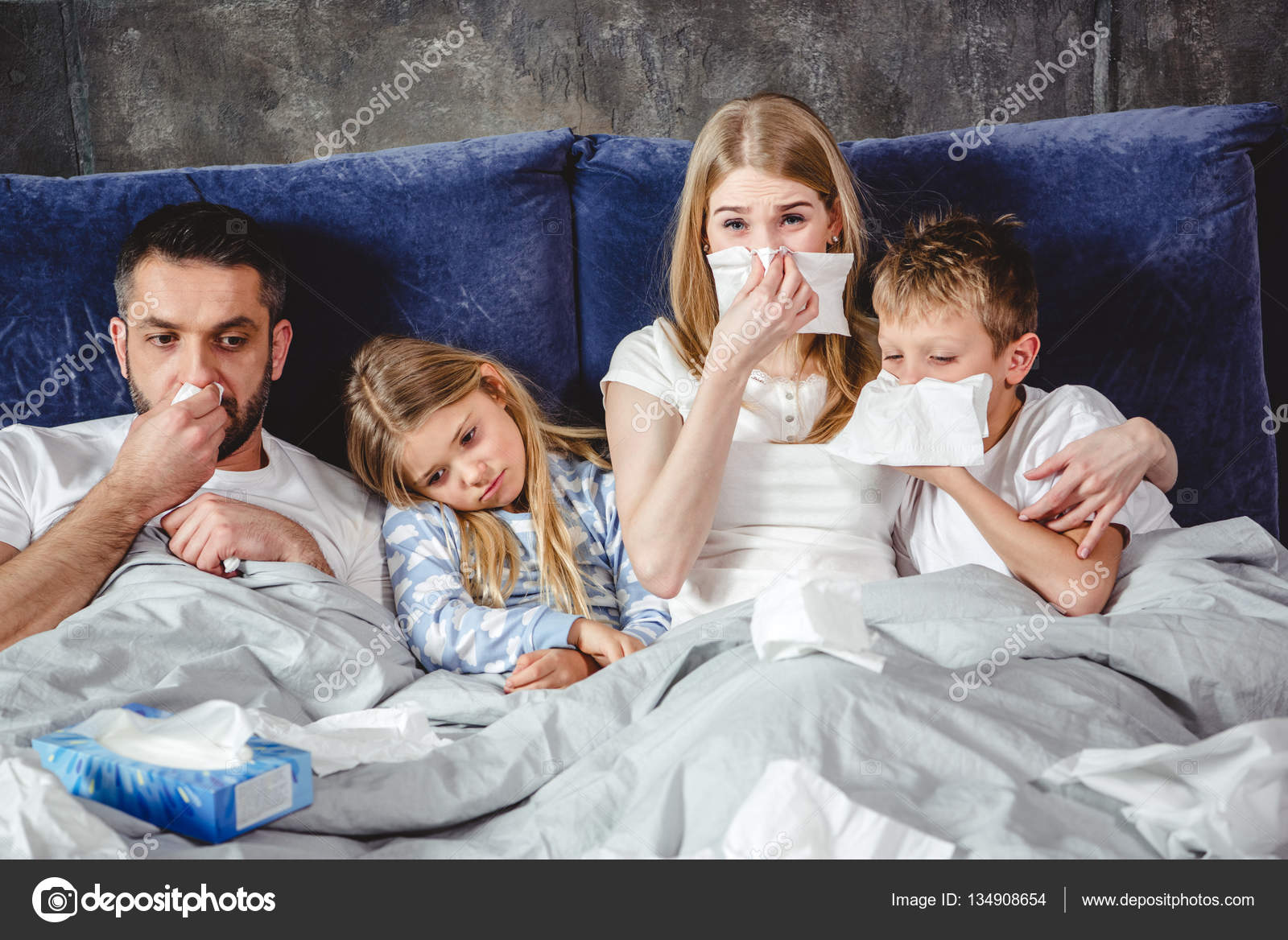 Sick family on bed Stock Photo by ©ArturVerkhovetskiy 134908654