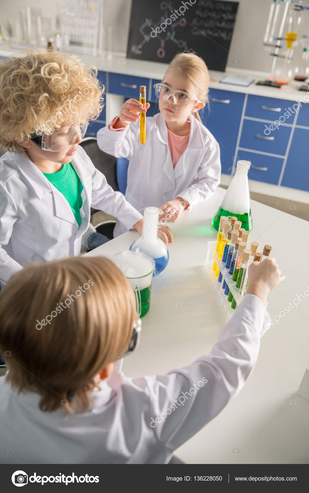 Schoolchildren making experiment — Stock Photo © ArturVerkhovetskiy ...