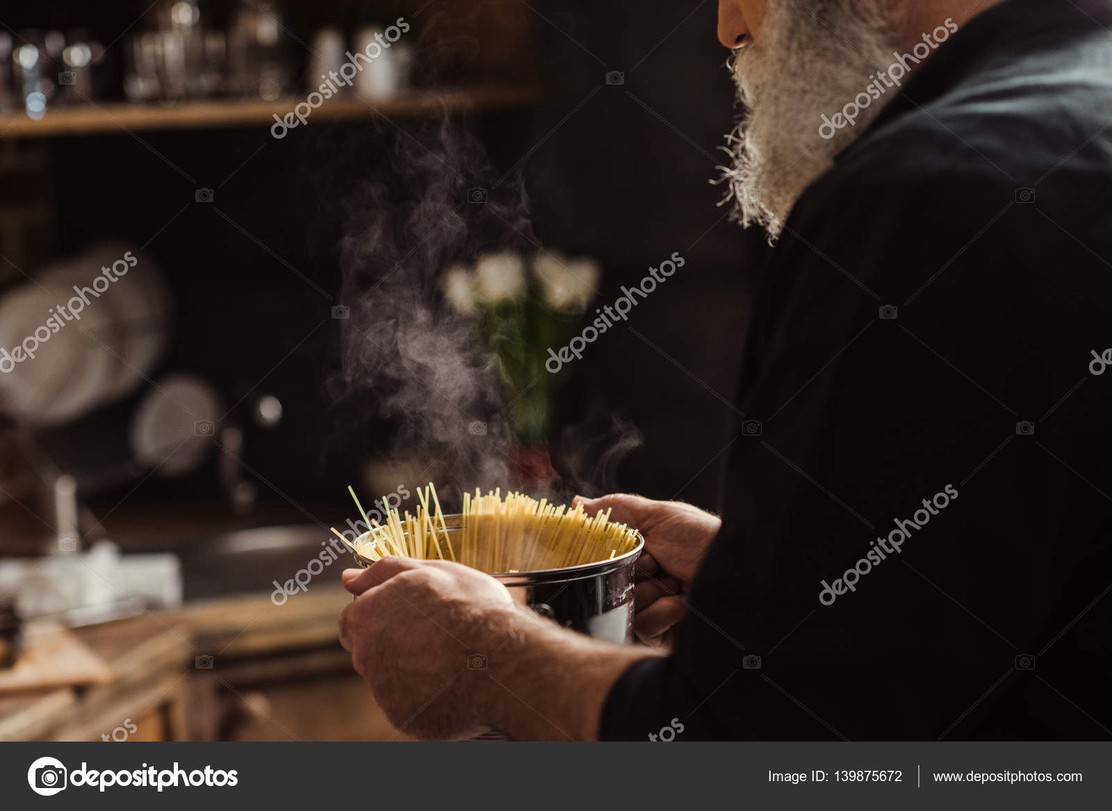 Man cooking spaghetti Stock Photo by ©ArturVerkhovetskiy 139875672