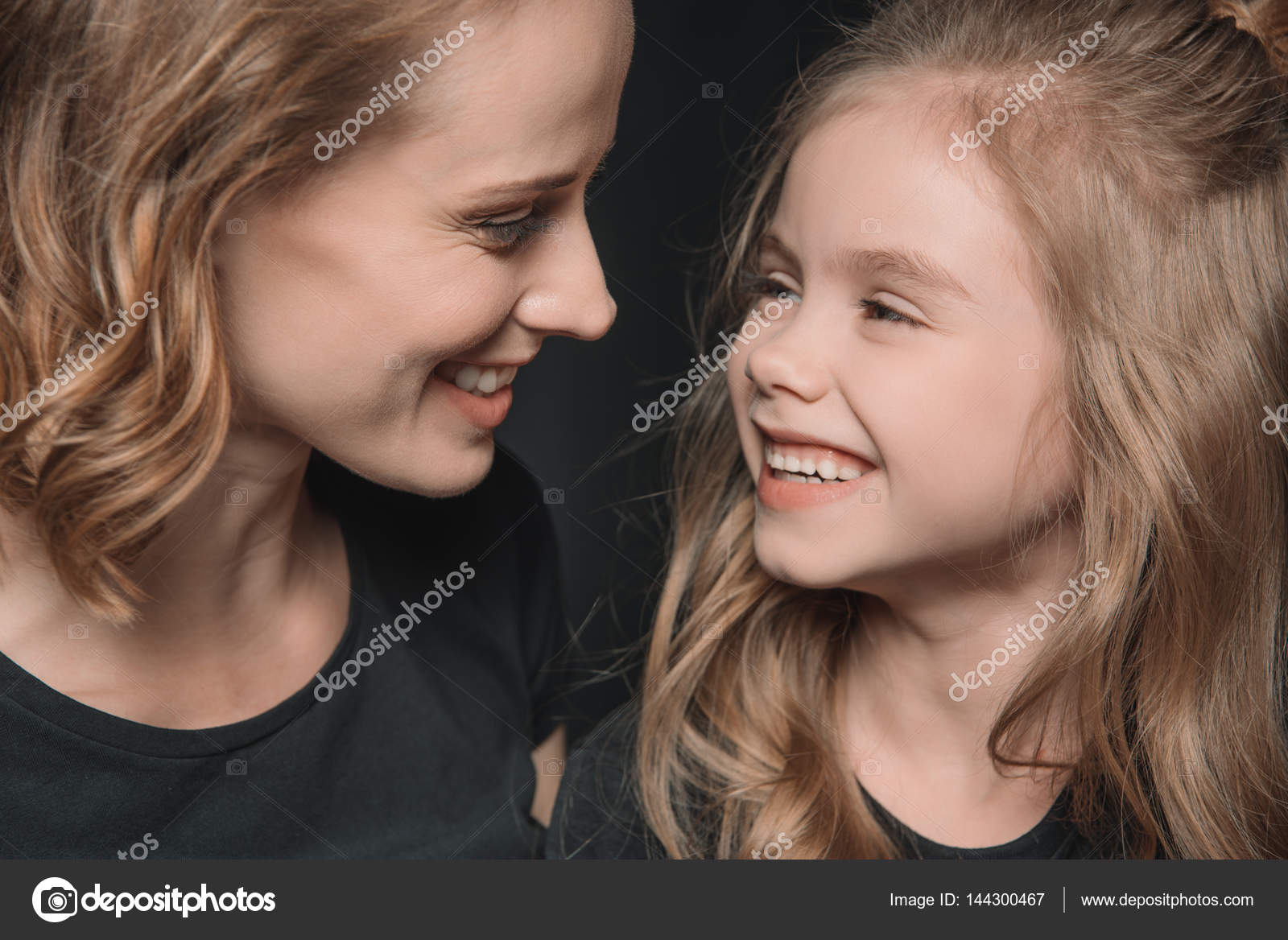 Daughter and mother smiling — Stock Photo © ArturVerkhovetskiy #144300467 Daughter and mother smiling — Stock Photo © ArturVerkhovetskiy #144300467
