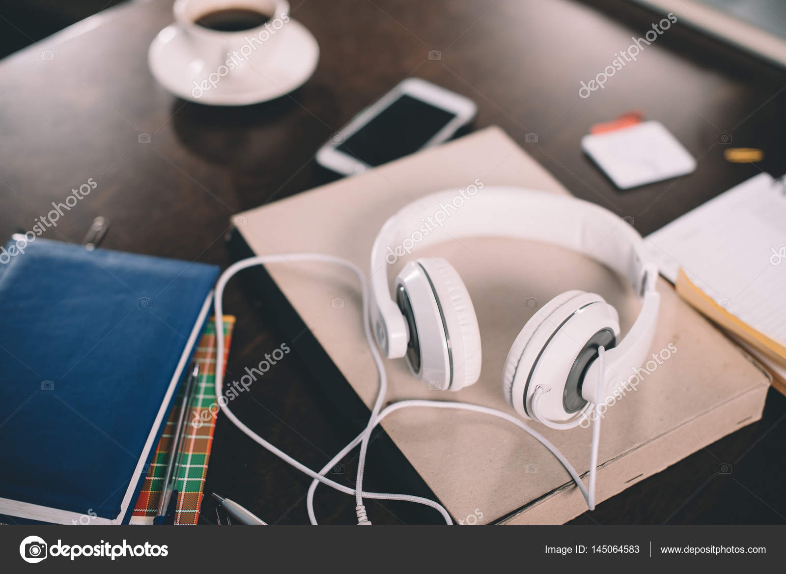 Book and headphones on table — Stock Photo © ArturVerkhovetskiy #145064583