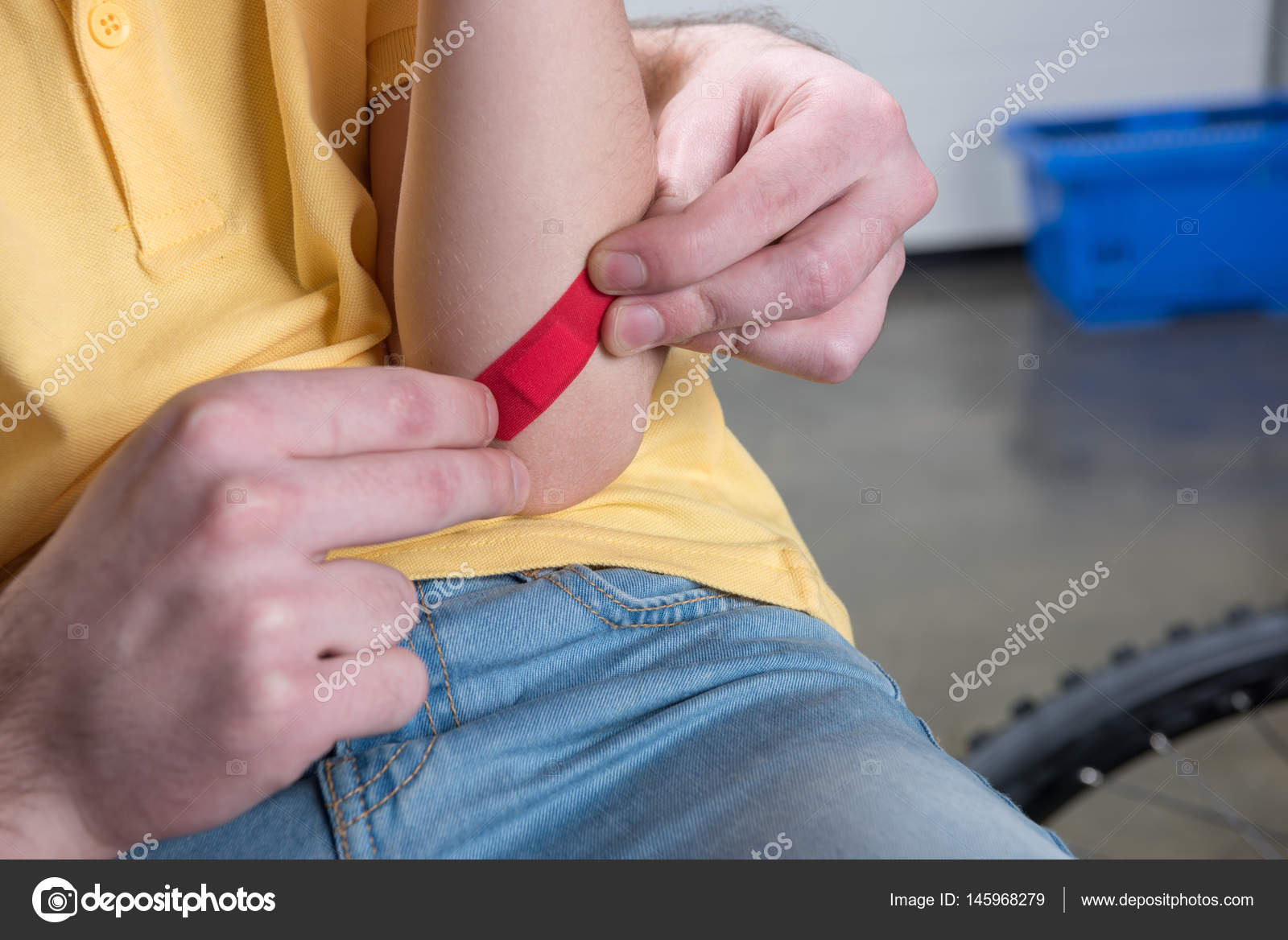 Father putting patch on son — Stock Photo © ArturVerkhovetskiy #145968279