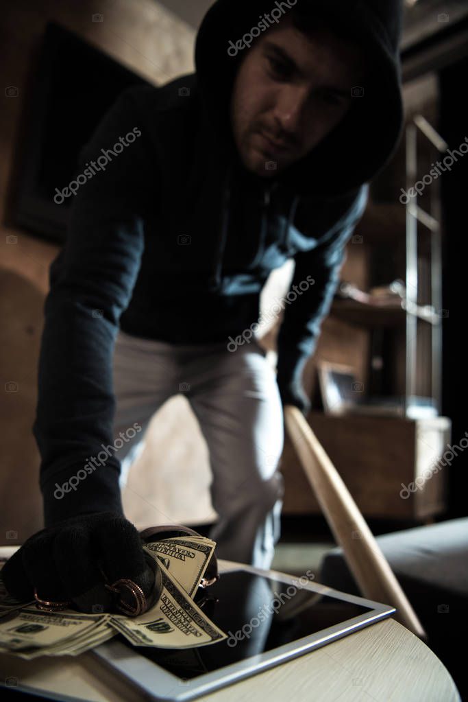 Robber stealing money — Stock Photo © ArturVerkhovetskiy #150249514