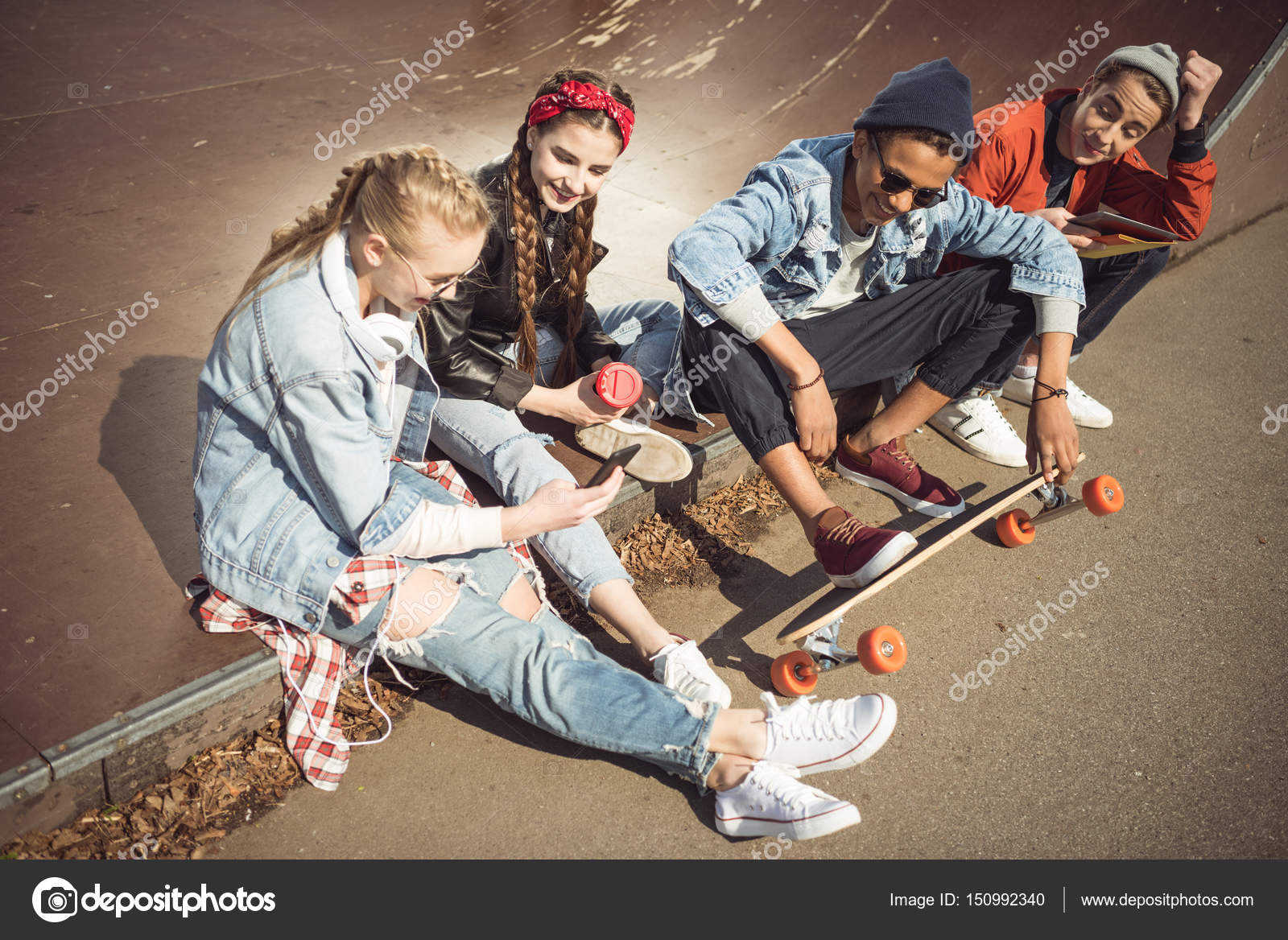 Teenagers using digital devices — Stock Photo © ArturVerkhovetskiy ...