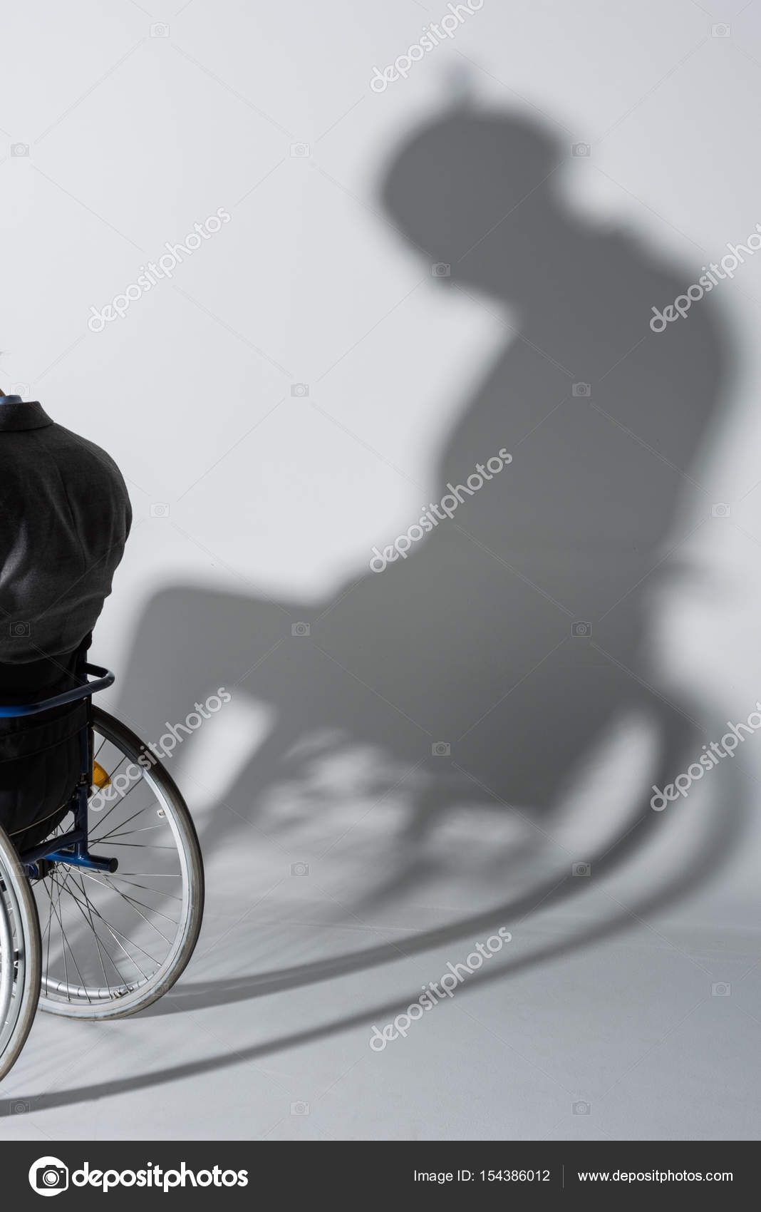Physically handicapped man in wheelchair with shadow — Stock Photo ...