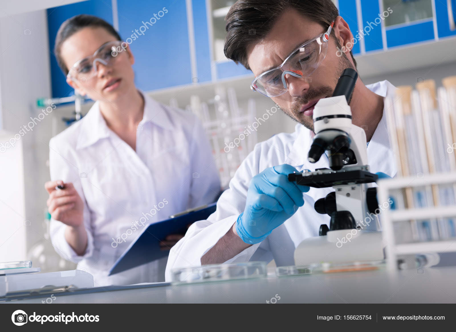 Scientists during work at laboratory — Stock Photo © ArturVerkhovetskiy ...