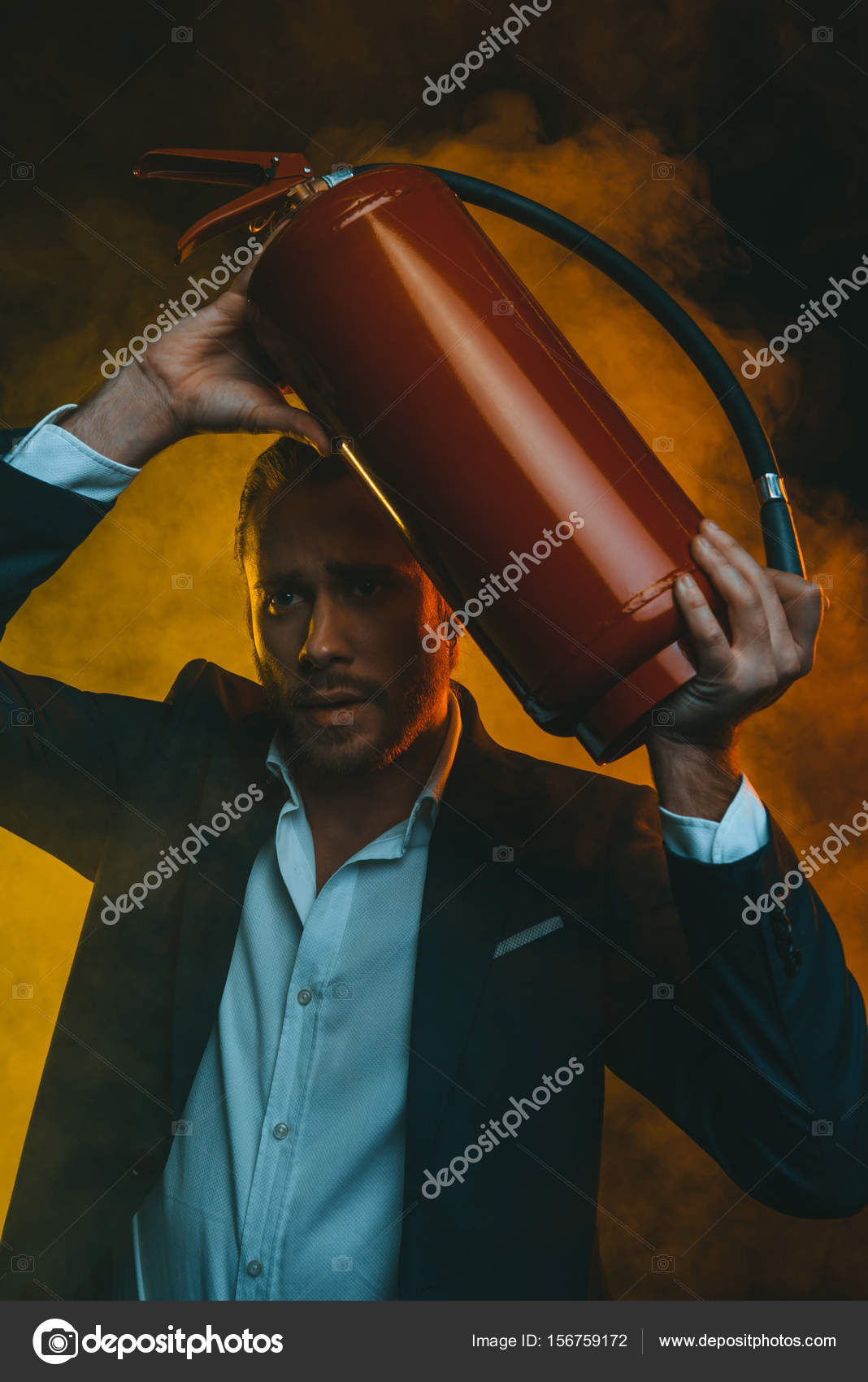 Man in suit holding fire extinguisher — Stock Photo ...