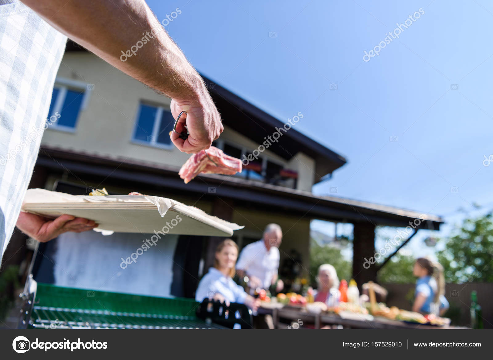 Man grilling meat — Stock Photo © ArturVerkhovetskiy #157529010