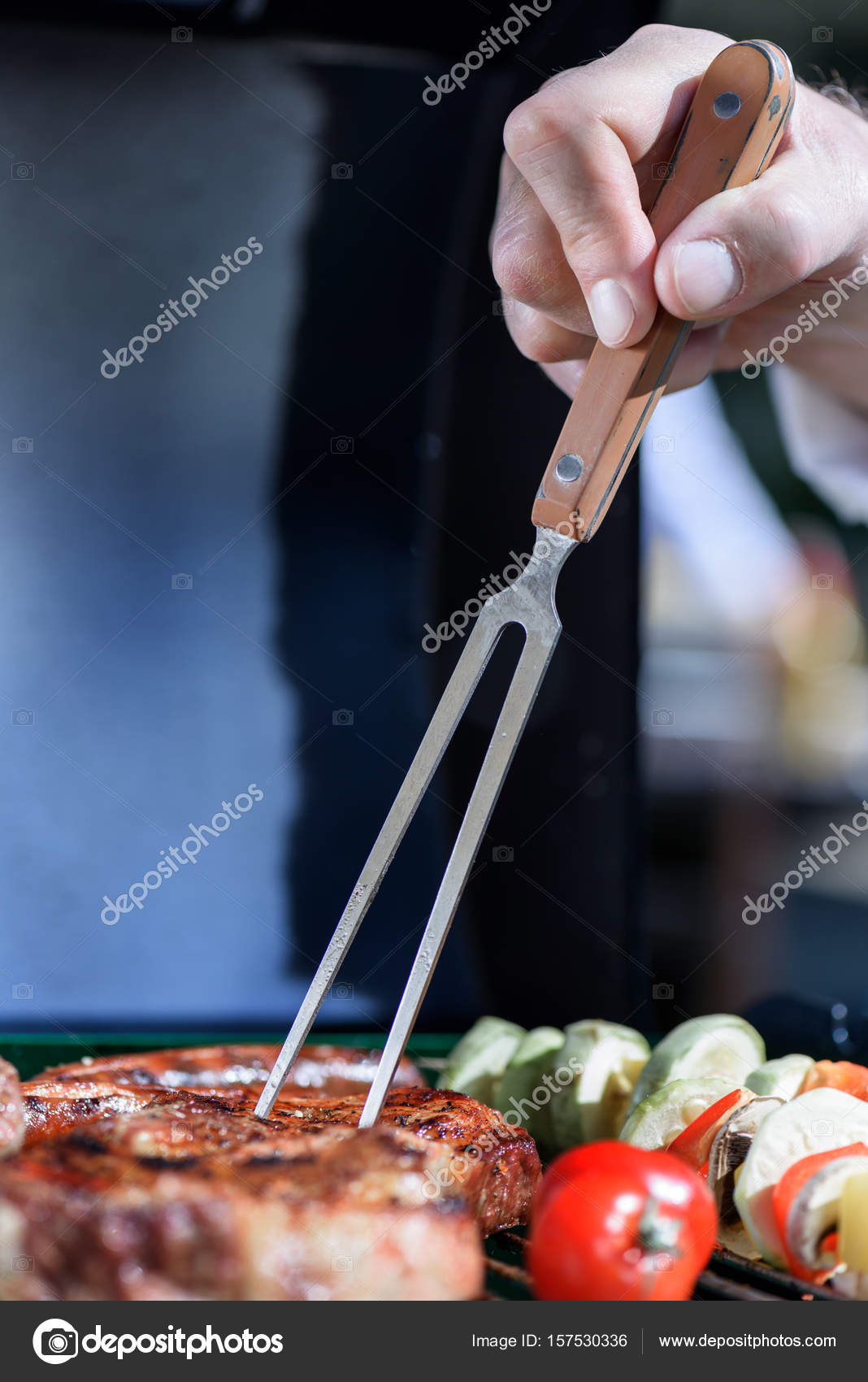 Hand pricking steak with barbecue fork — Stock Photo ...