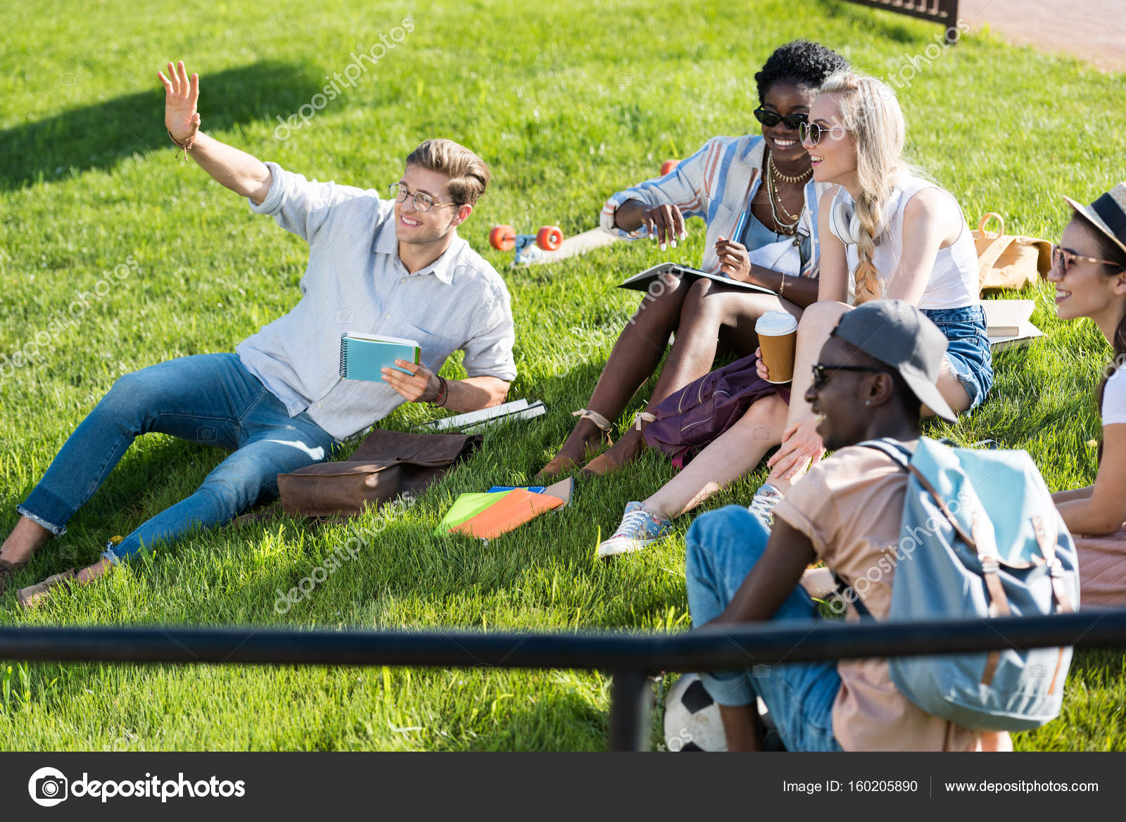 Multiethnic students resting in park — Stock Photo © ArturVerkhovetskiy ...