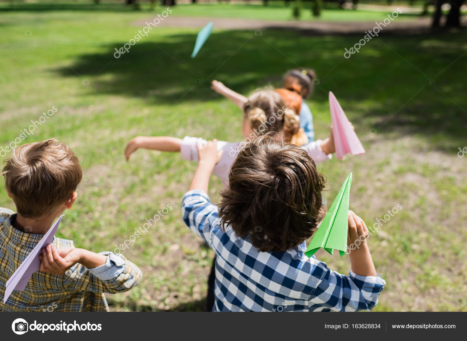 Kids playing with paper planes — Stock Photo © ArturVerkhovetskiy ...