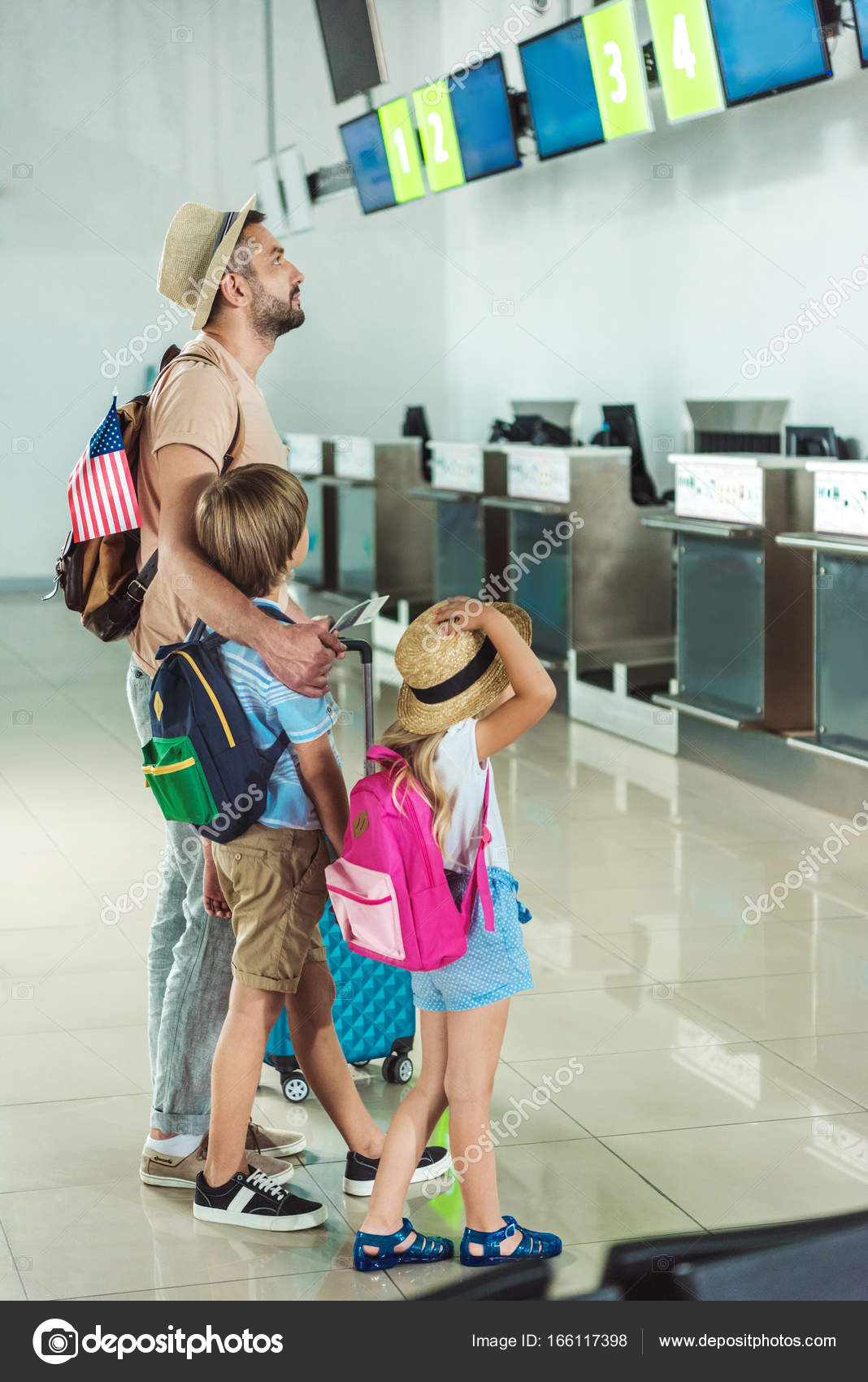 Father and kids at check in desk — Free Stock Photo ...
