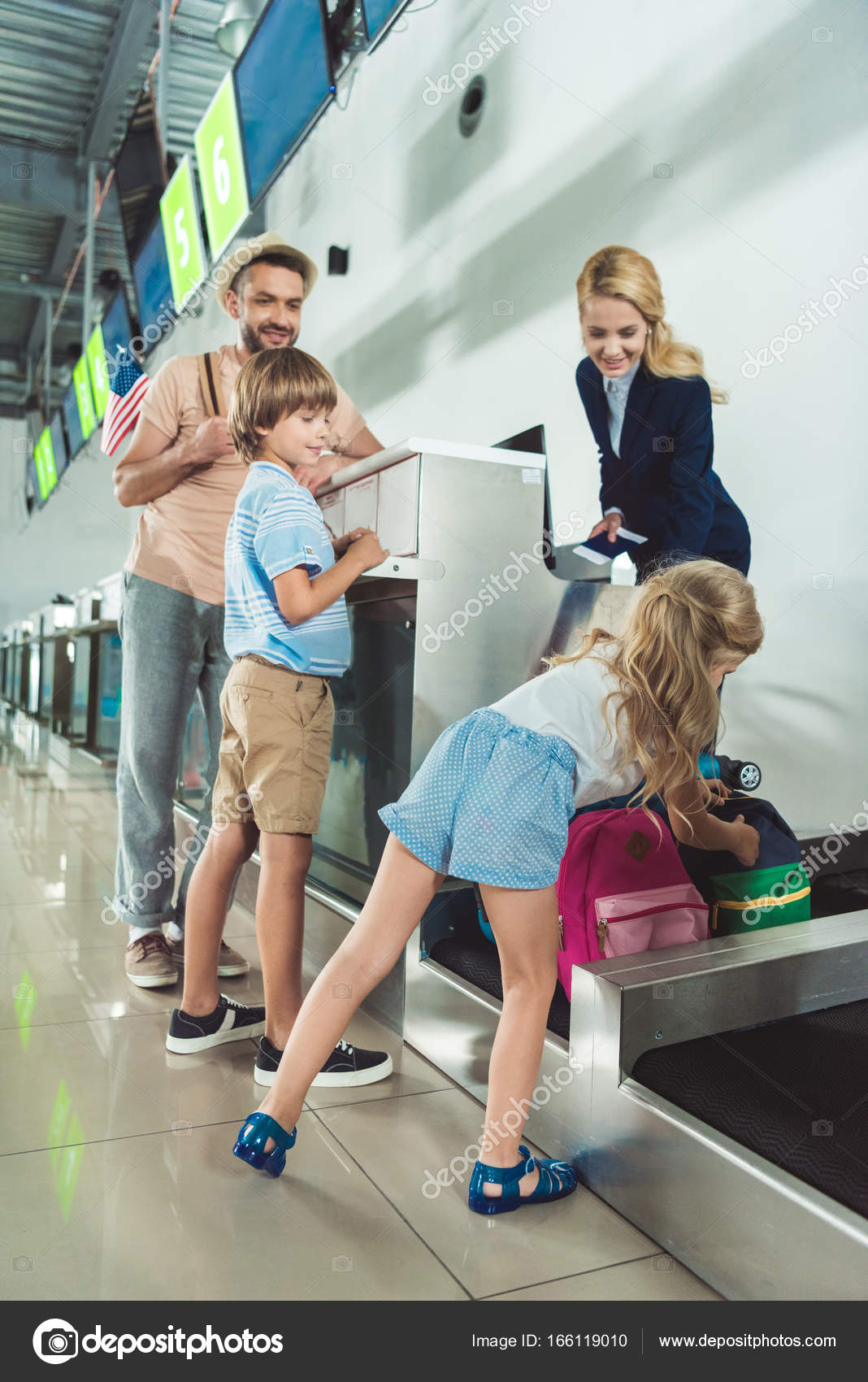 Family at check in desk at airport — Stock Photo © ArturVerkhovetskiy ...