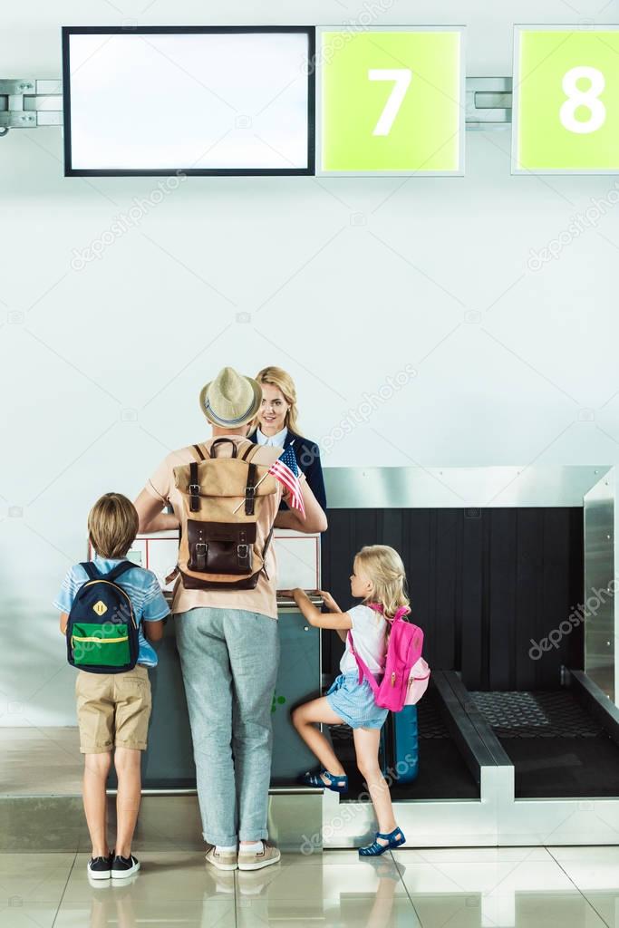 Family at check in desk at airport — Stock Photo © ArturVerkhovetskiy ...