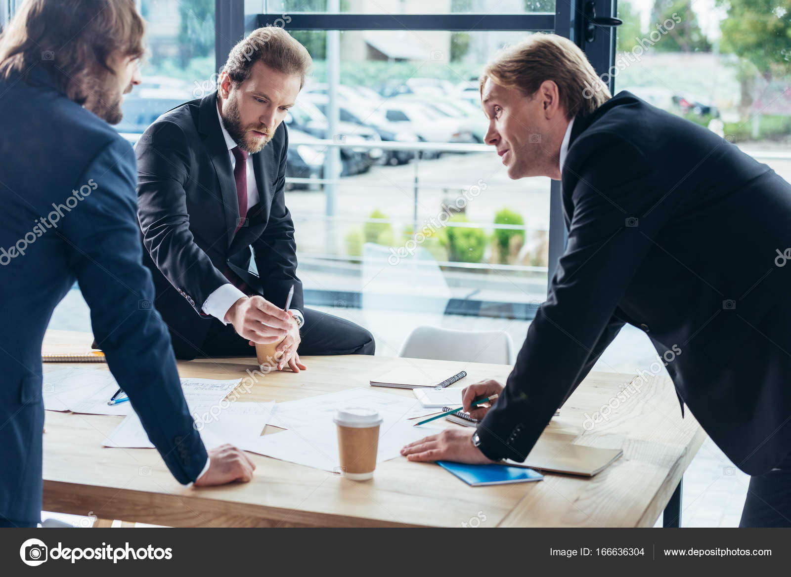 Businessmen working in office — Stock Photo © ArturVerkhovetskiy #166636304