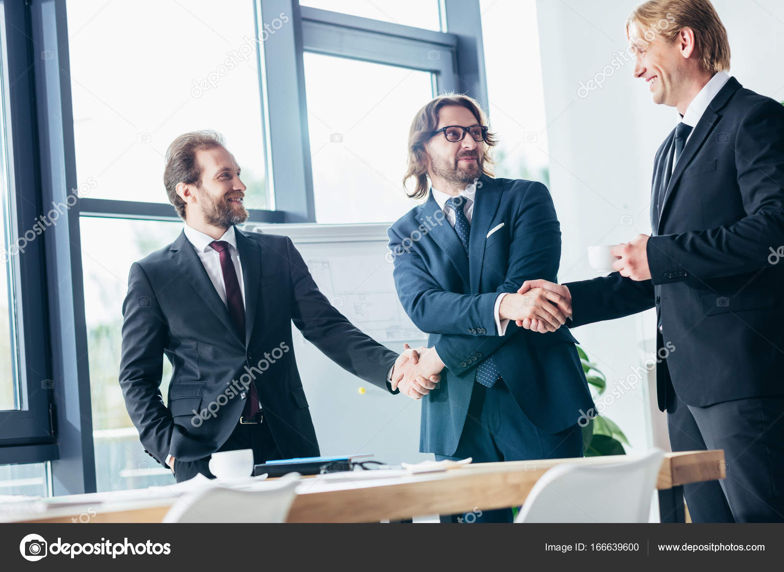 Businessmen shaking hands — Stock Photo © ArturVerkhovetskiy #166639600
