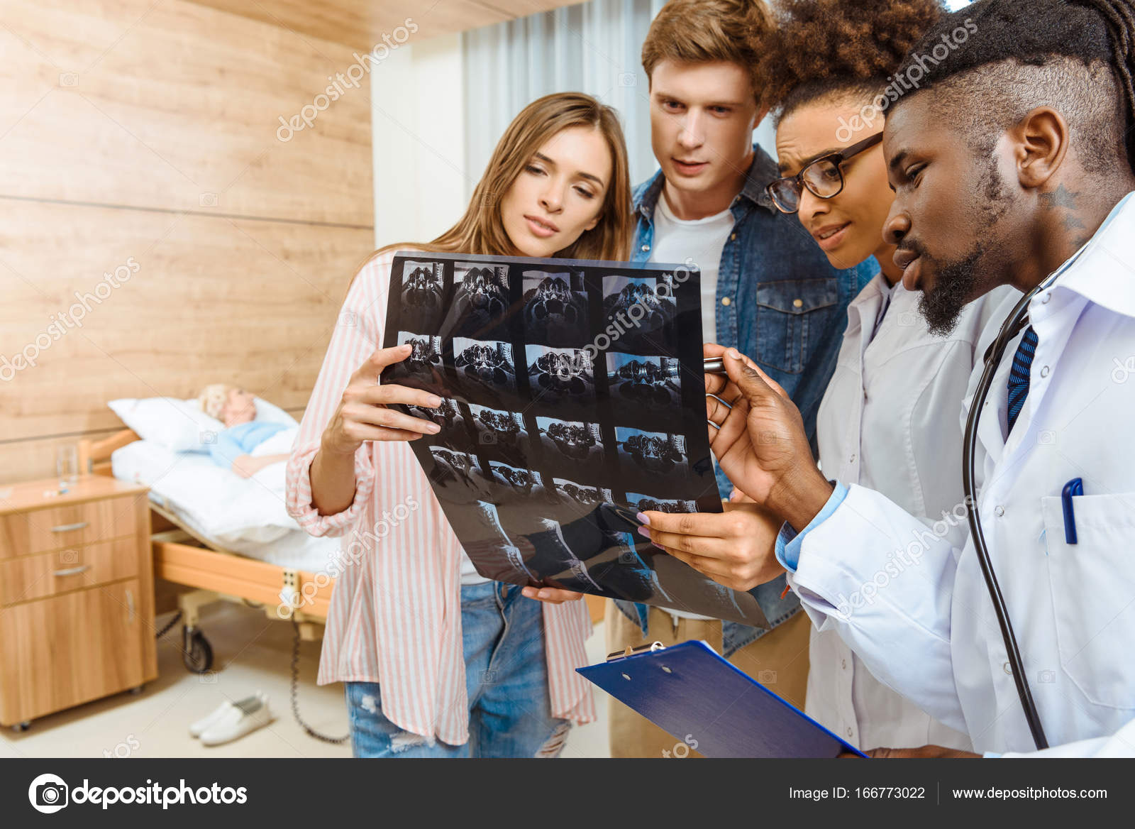 Doctors and patients examining X-ray — Stock Photo © ArturVerkhovetskiy ...