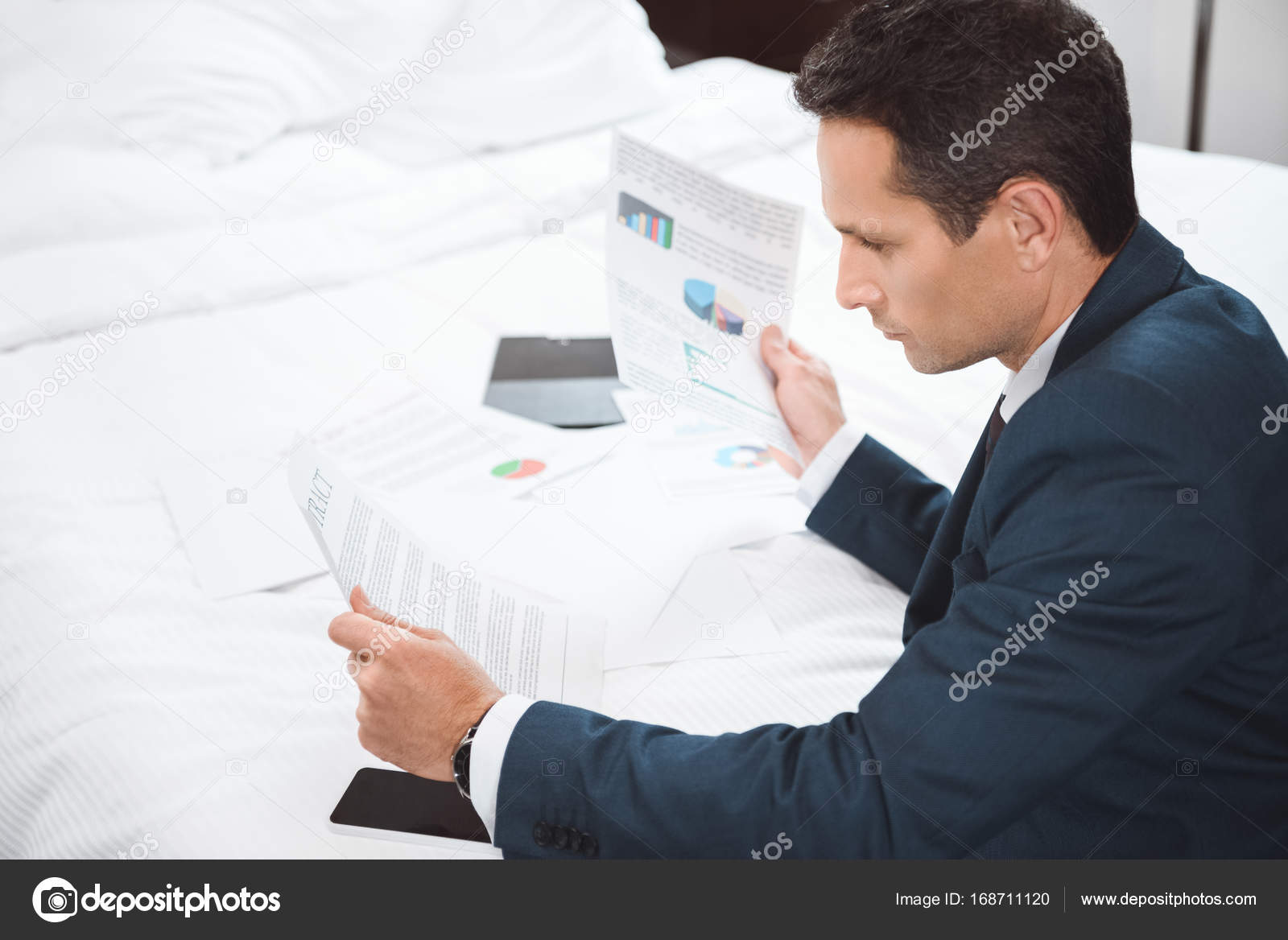 Businessman reading paperwork — Free Stock Photo © ArturVerkhovetskiy ...