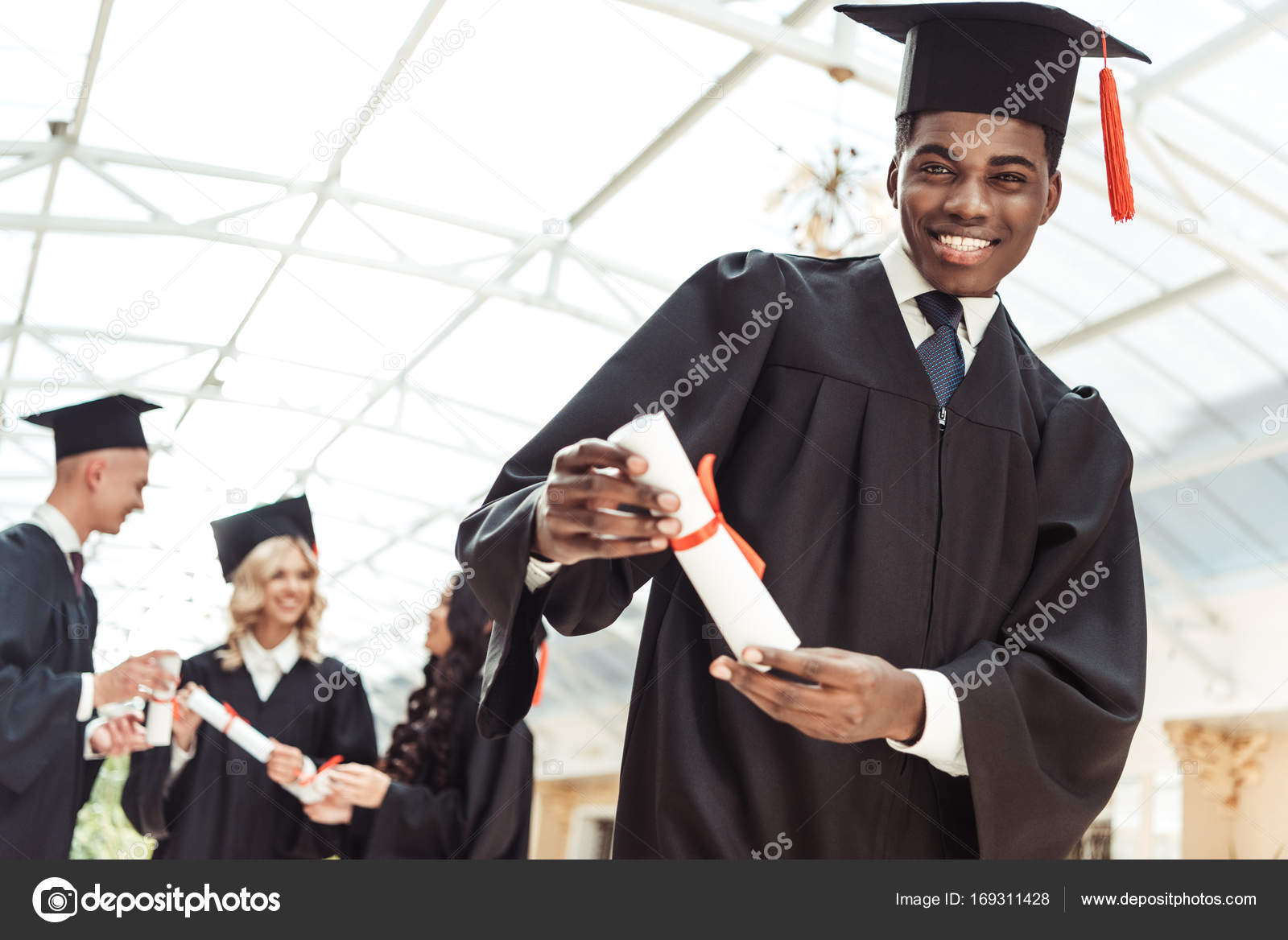 Graduated student showing diploma — Stock Photo © ArturVerkhovetskiy ...