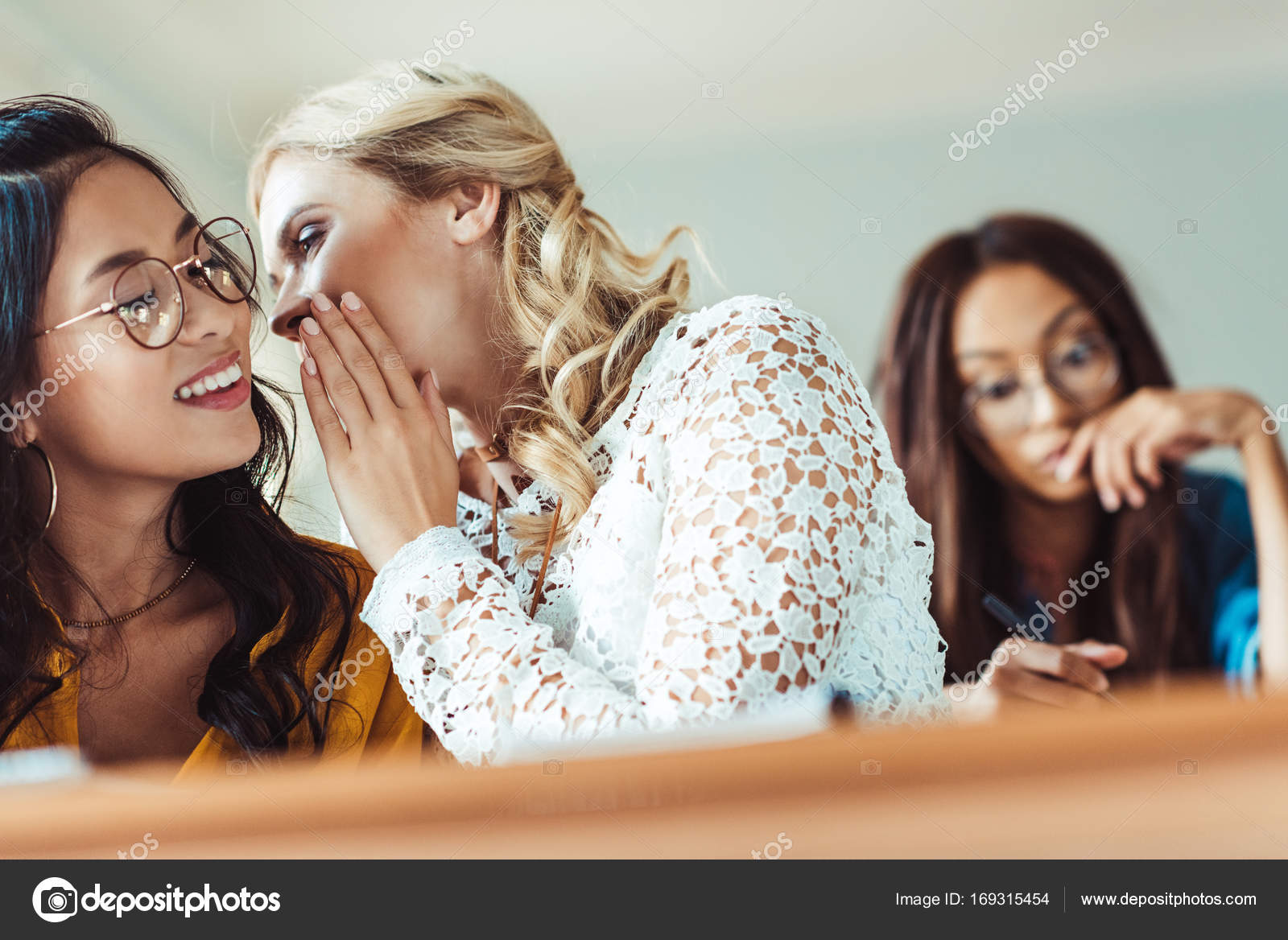 Student girls gossiping in class — Stock Photo © ArturVerkhovetskiy ...