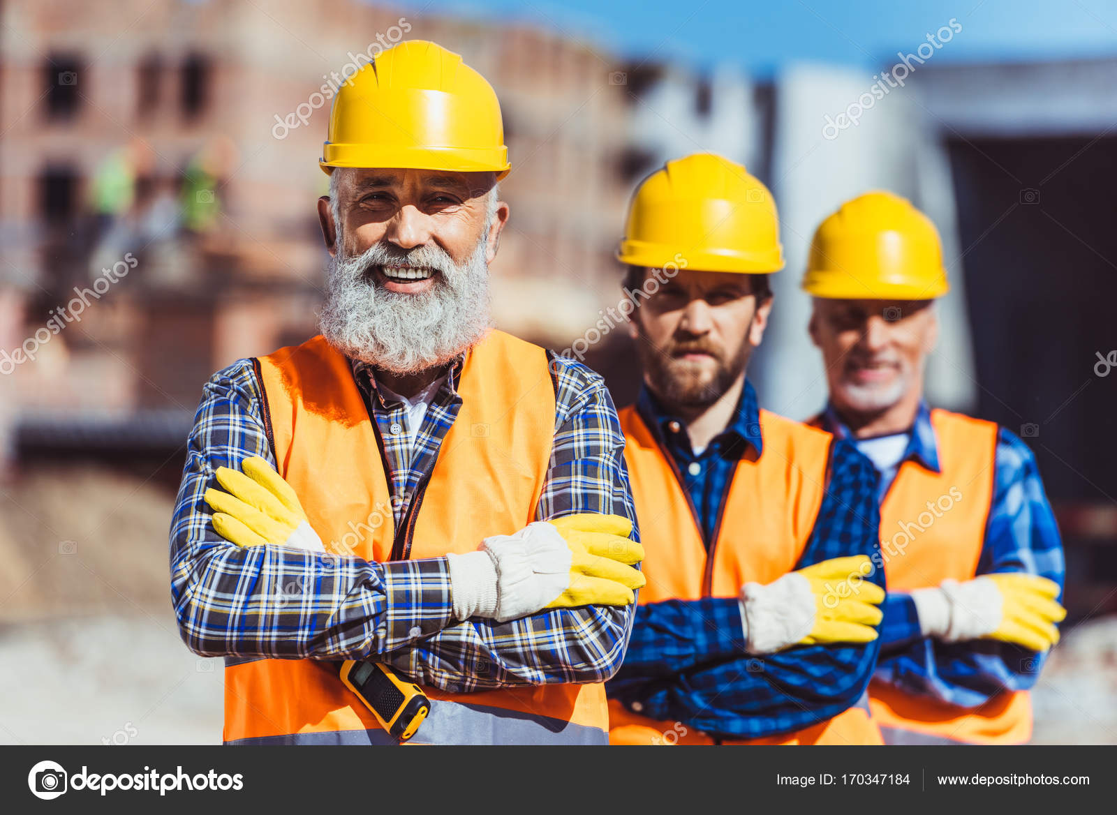 Construction workers at site — Stock Photo © ArturVerkhovetskiy #170347184