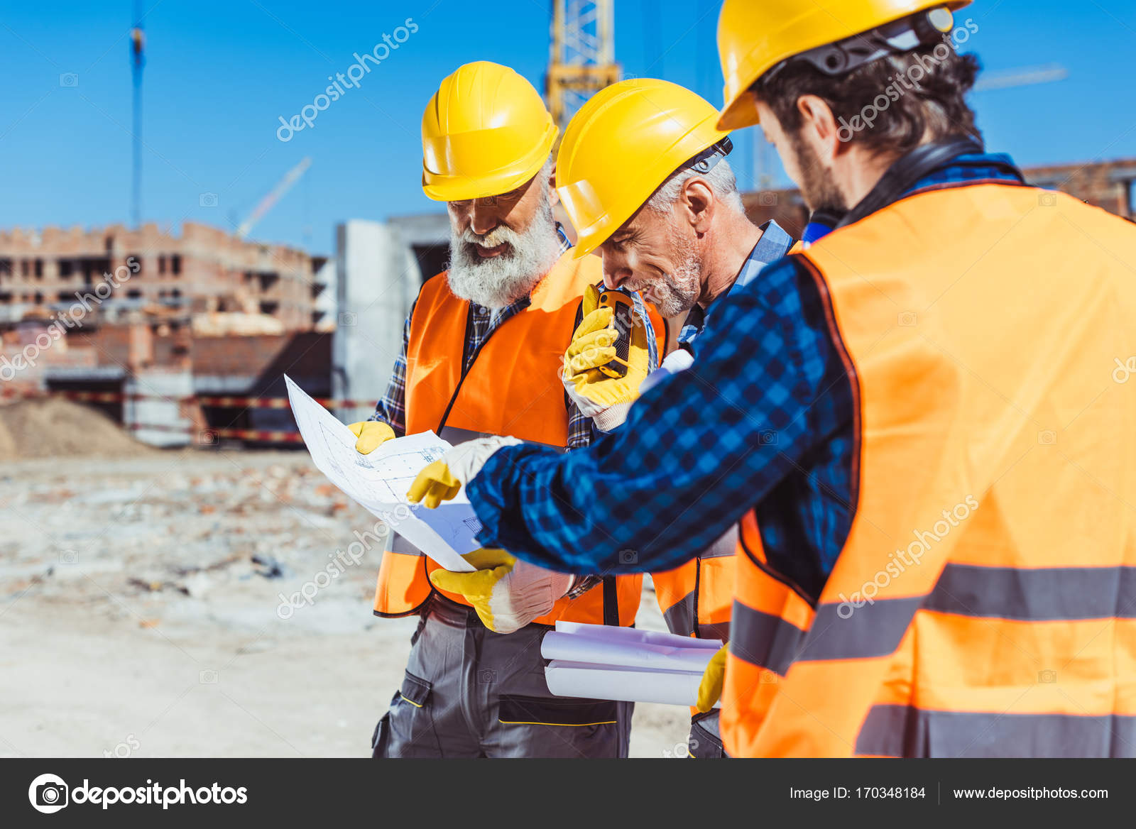 Construction workers discussing building plans Stock Photo by ...