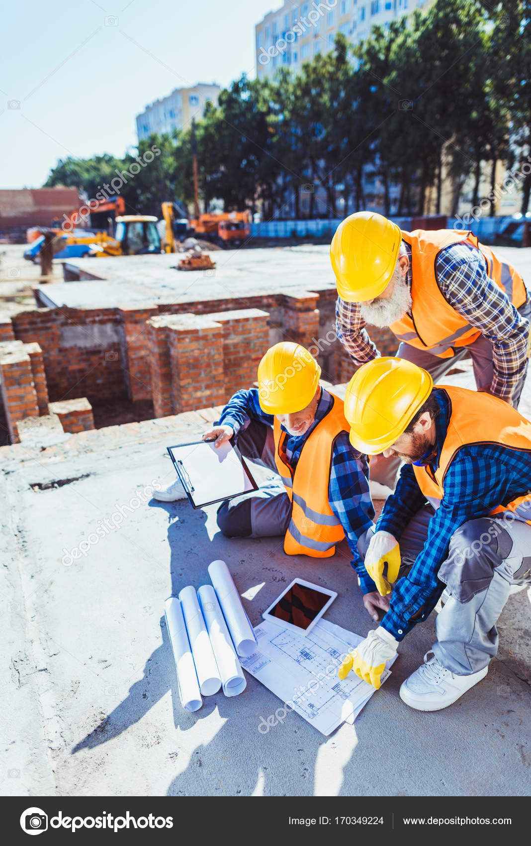 Construction workers examining building plans — Stock Photo ...