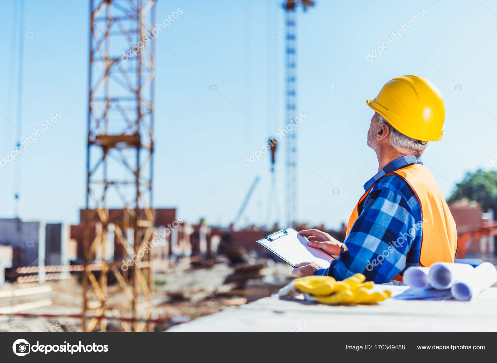 Construction worker writing on clipboard — Stock Photo ...