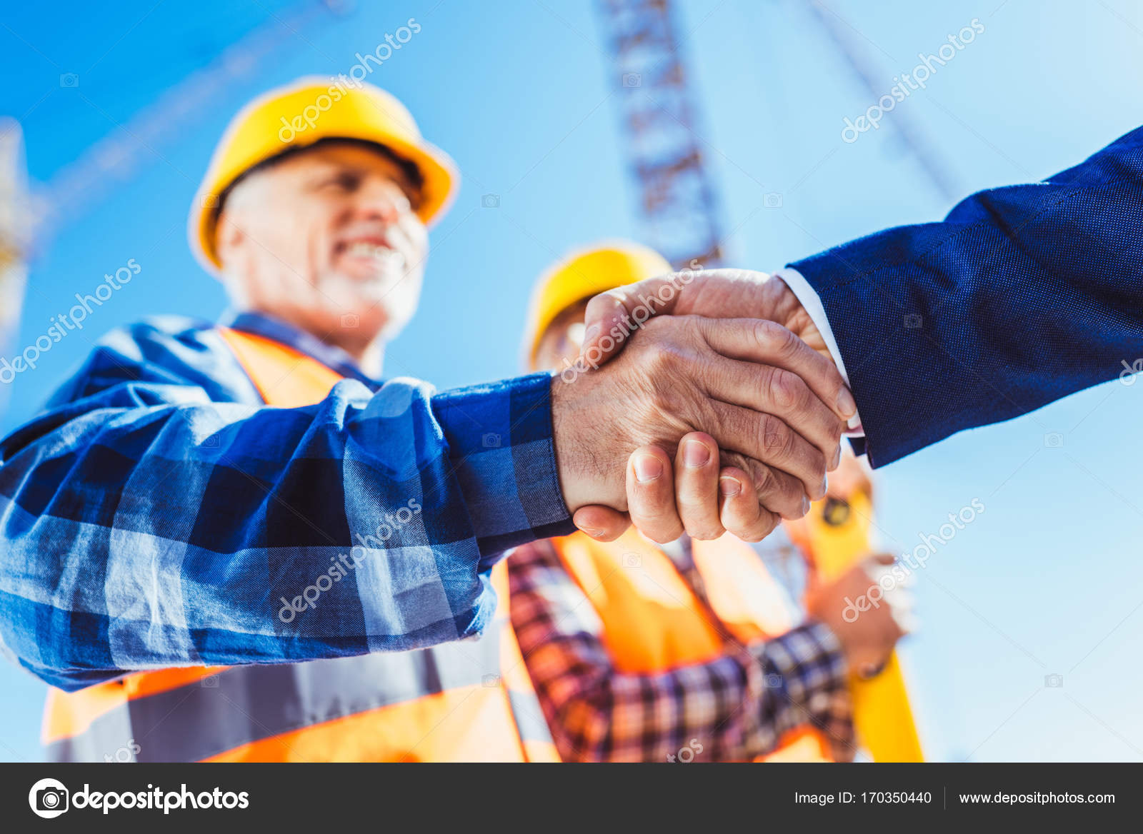 Builder and businessman shaking hands — Stock Photo ...